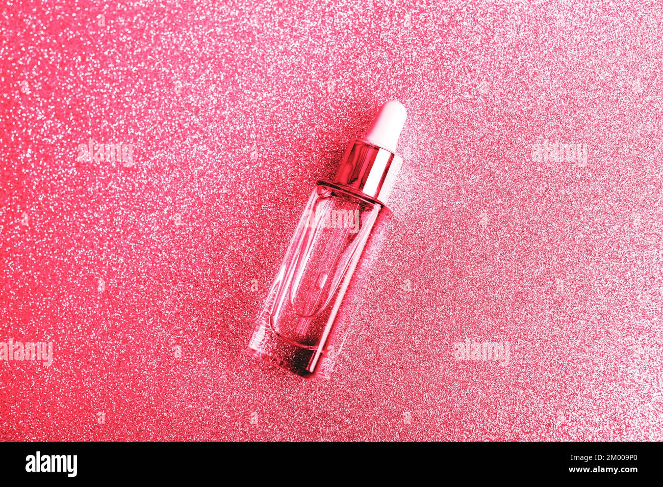 Cosmetic purple serum bottle on sparkling viva magenta background ...
