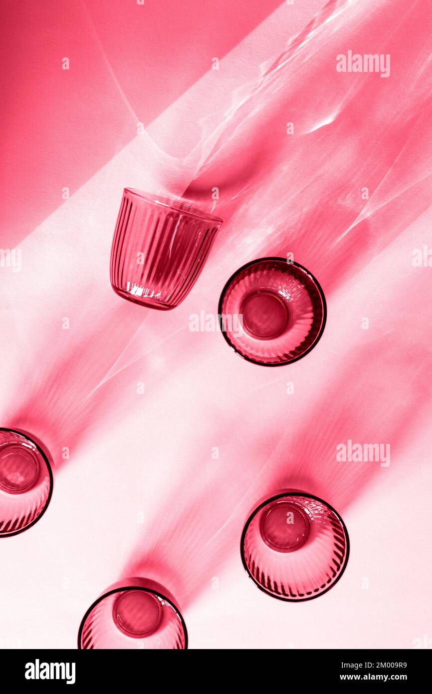 Viva magenta glasses with shadows in sunlight. Still life Stock Photo ...