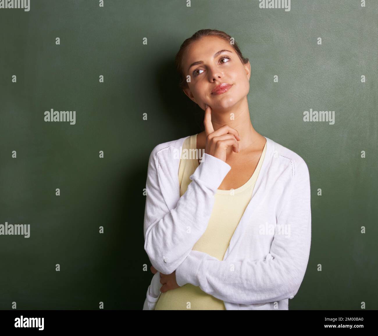 Re-thinking the curriculum. A beautiful young teacher standing in front ...