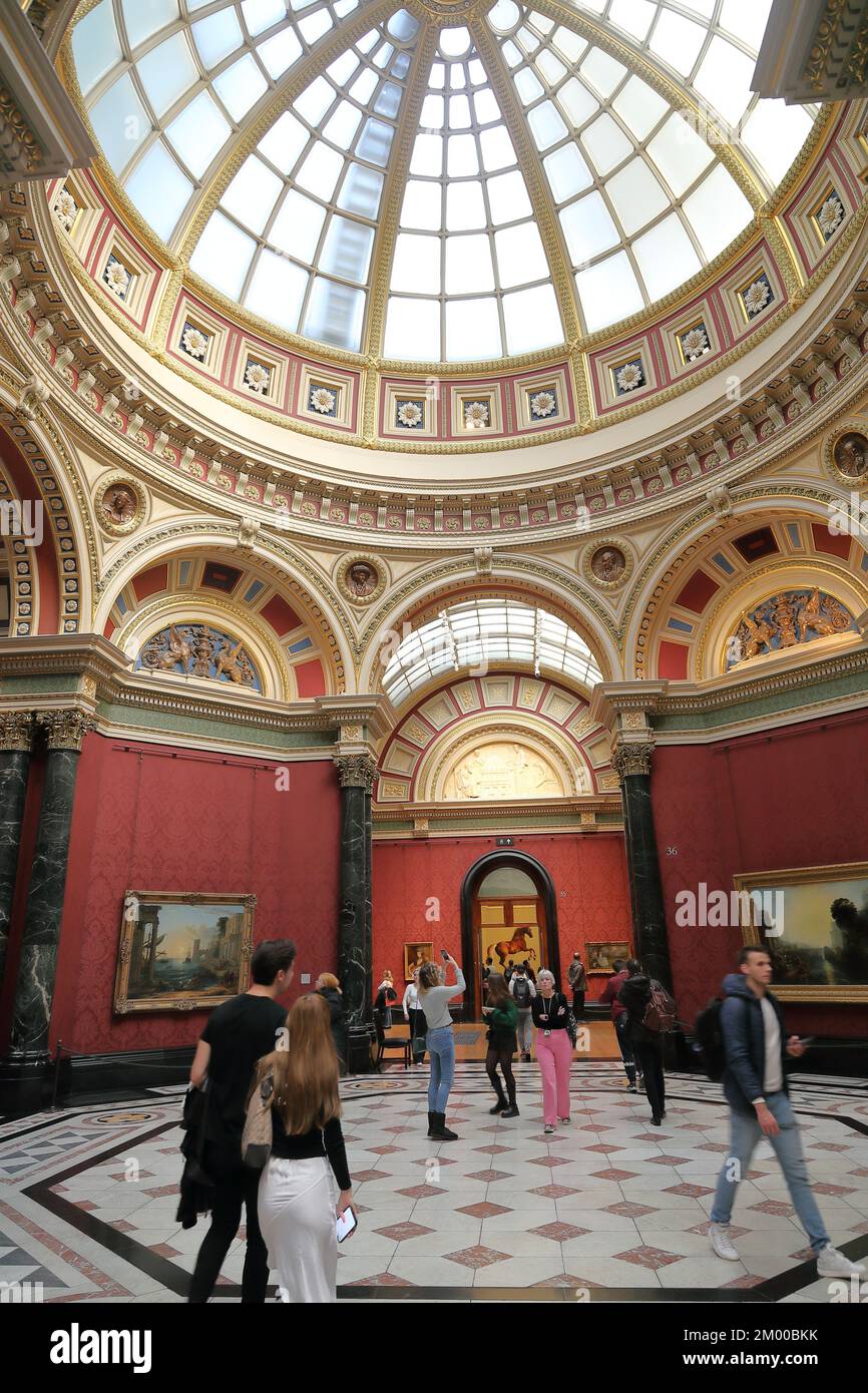 Visitors study Renaissance paintings in the National Gallery, London ...