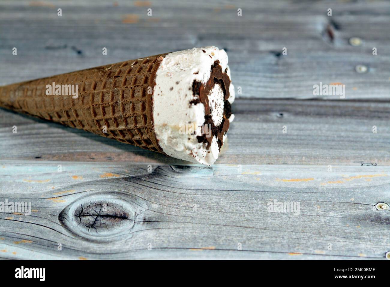 Ice cream vanilla cone with topping of chocolate chips pieces in a ...