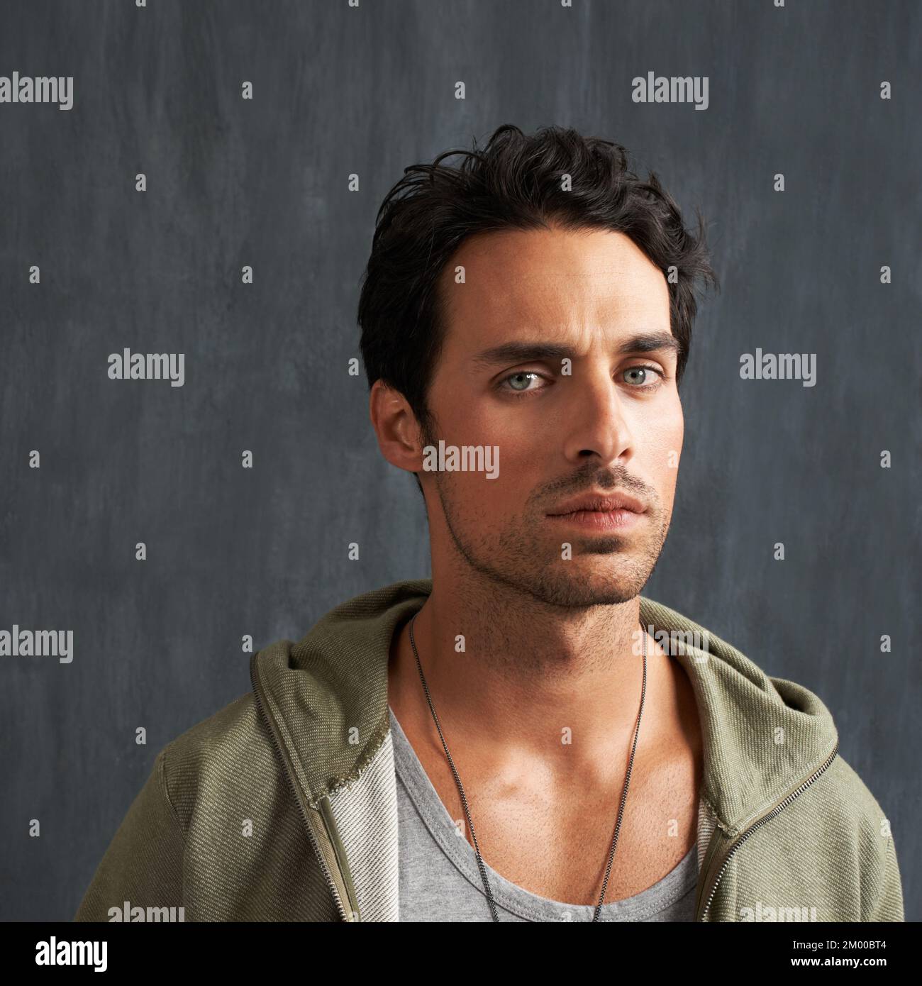 Giving you a serious stare. Portrait of a handsome young man looking ...