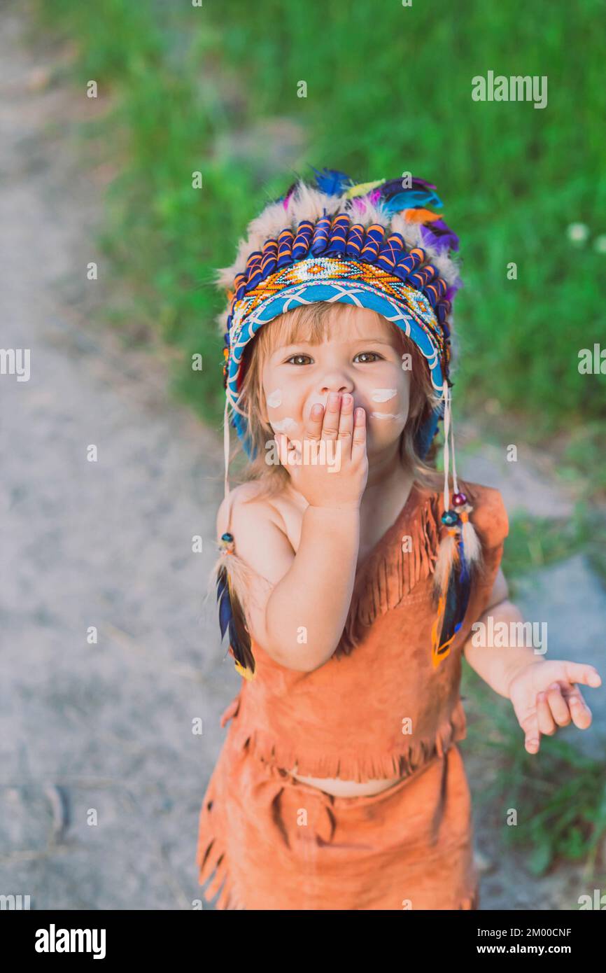 Adorable baby dressed as a Native American makes a battle cry Stock ...