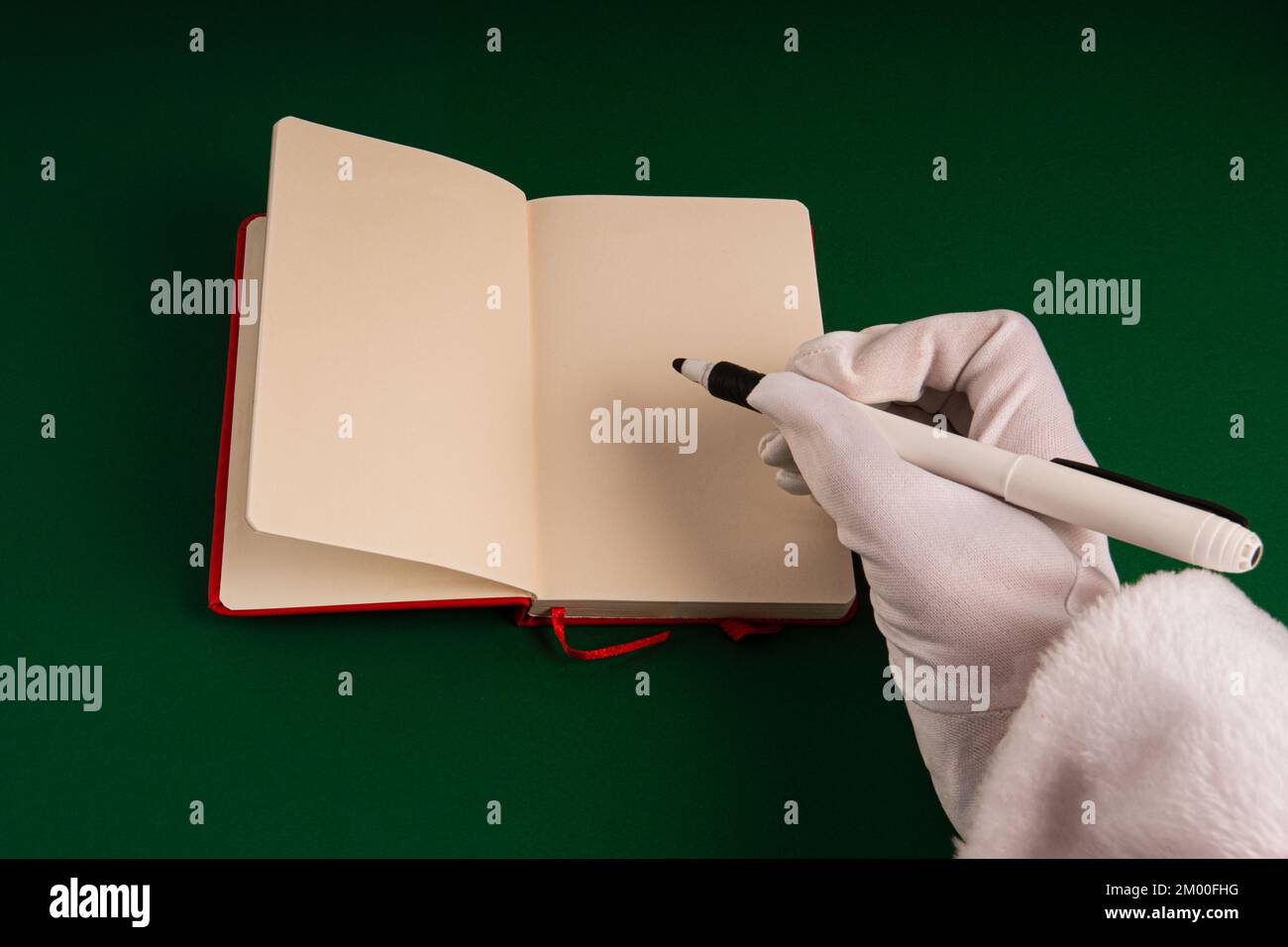 Santa Claus's hands writing his list Stock Photo - Alamy