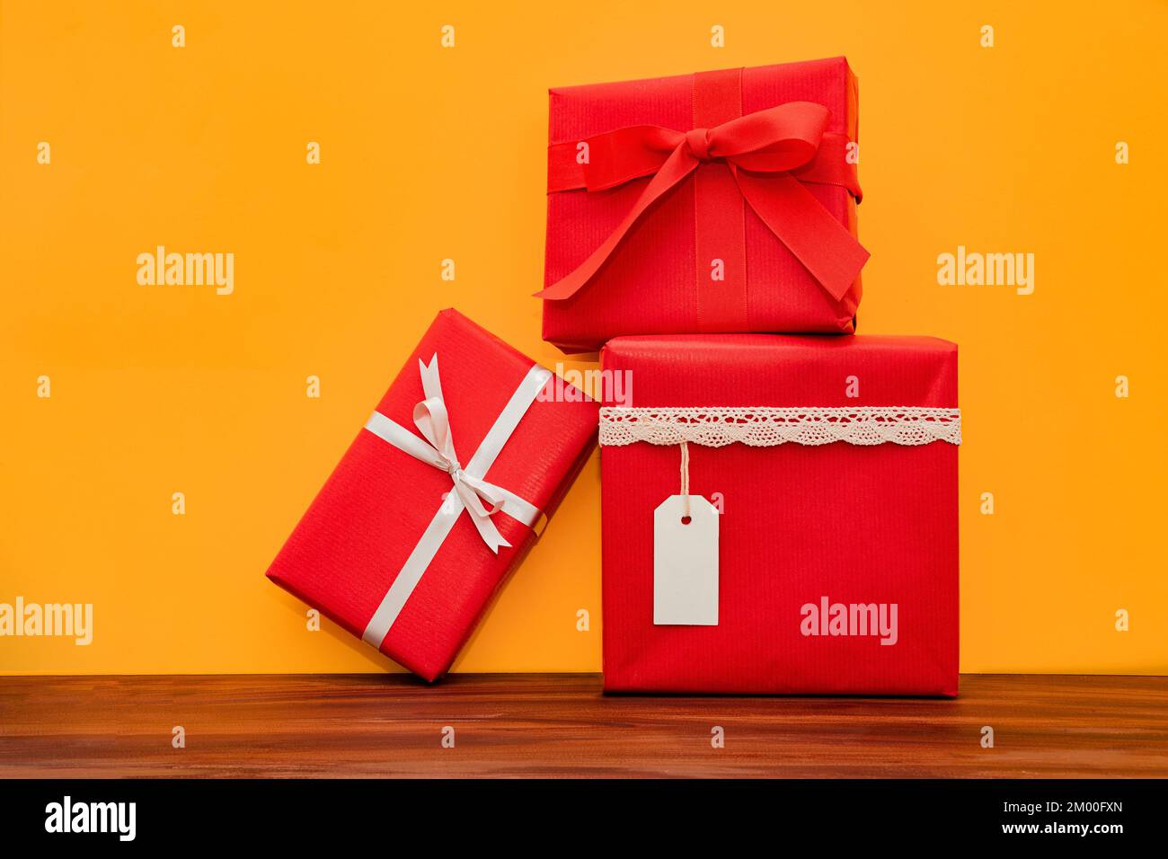 Still life of wrapped boxes in red with ribbons for gifts Stock Photo ...
