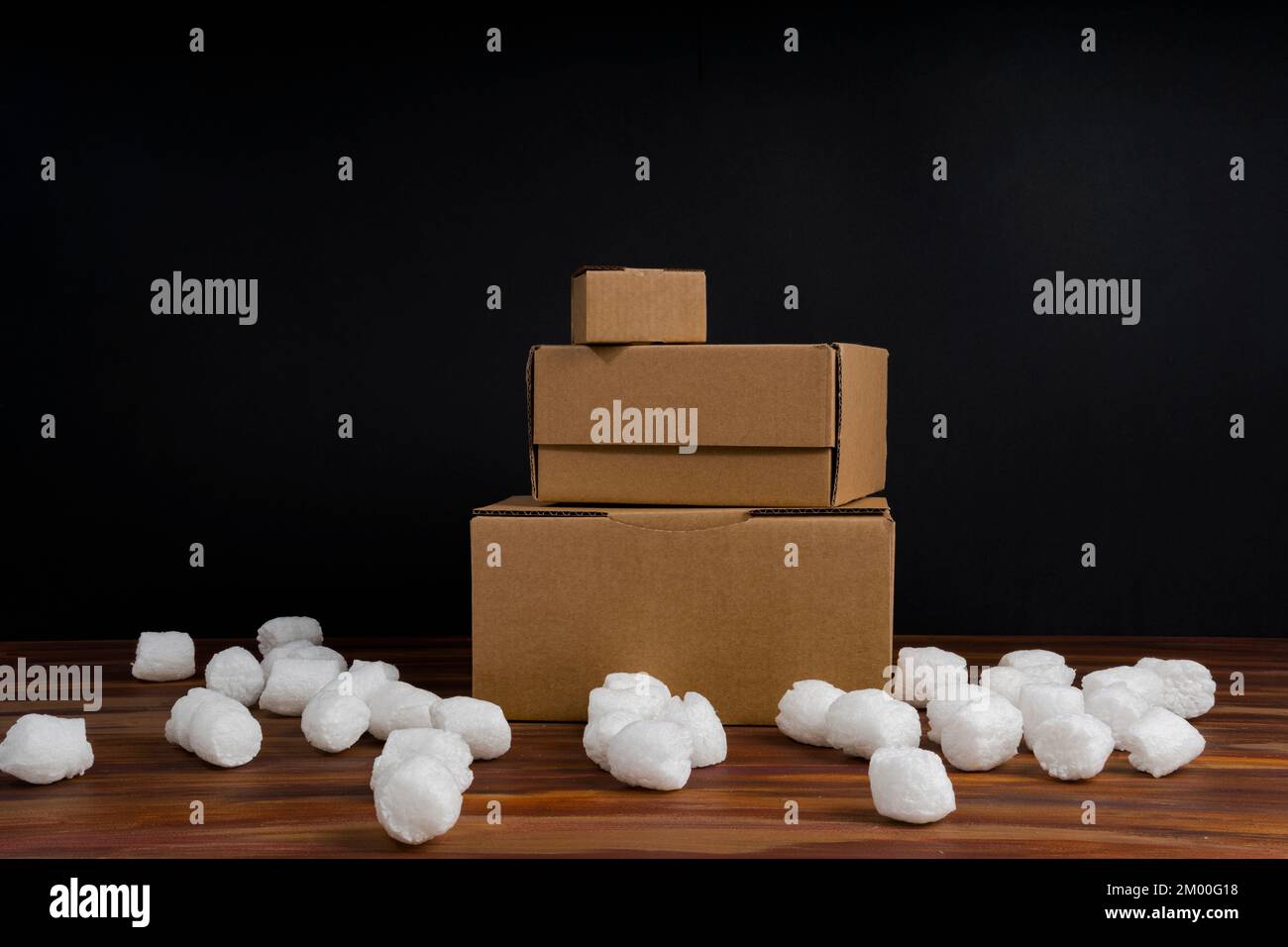 Frontal view of a pile of three cardboard boxes with shipping chips ...