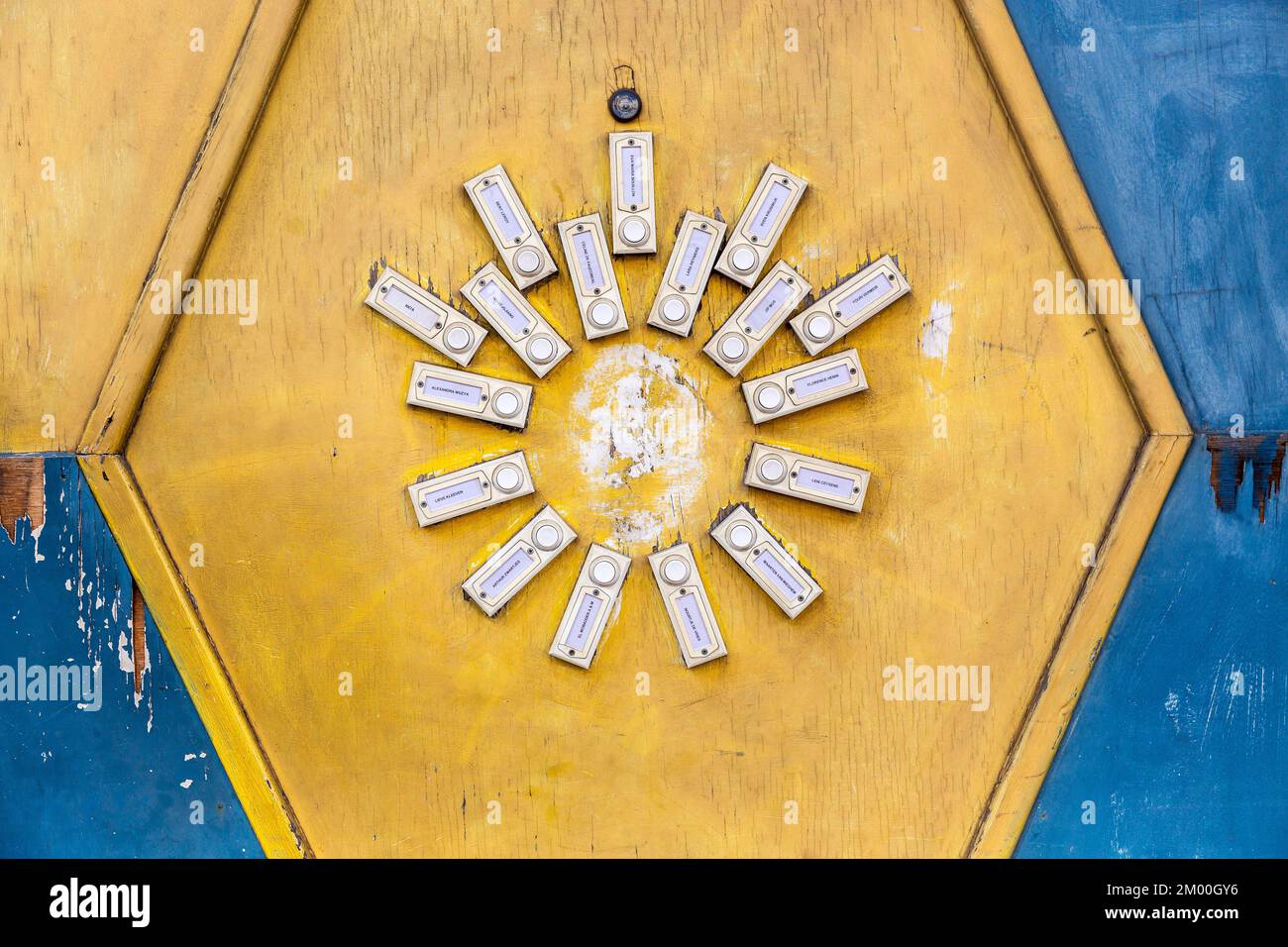 Ring of bells on a door with yellow and blue geometric patterns ...