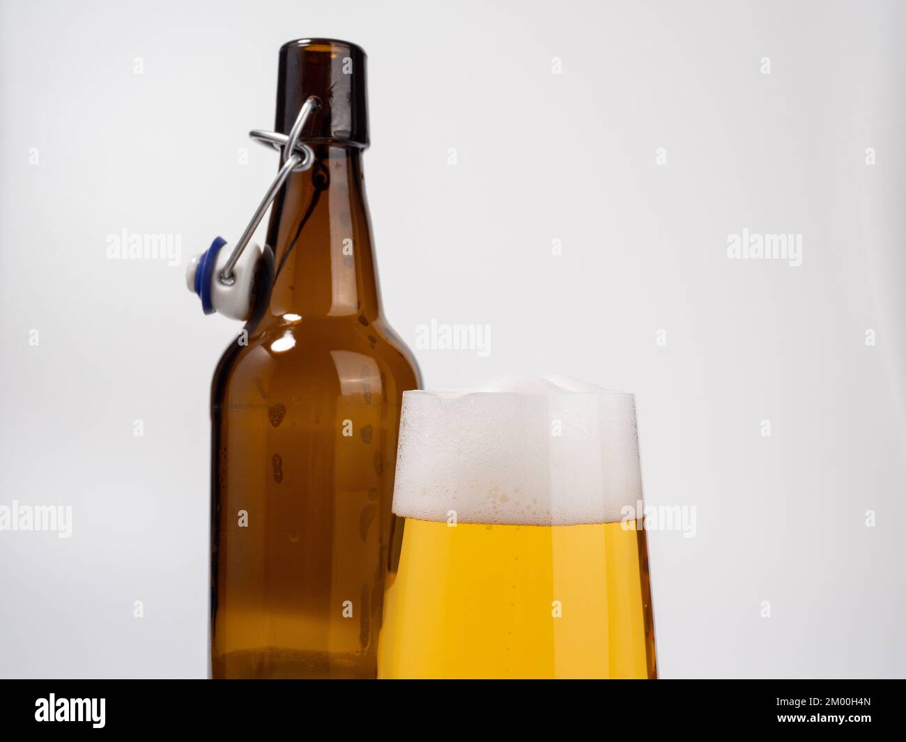 Glass and bottle of beer on a white background. Glass of light beer ...