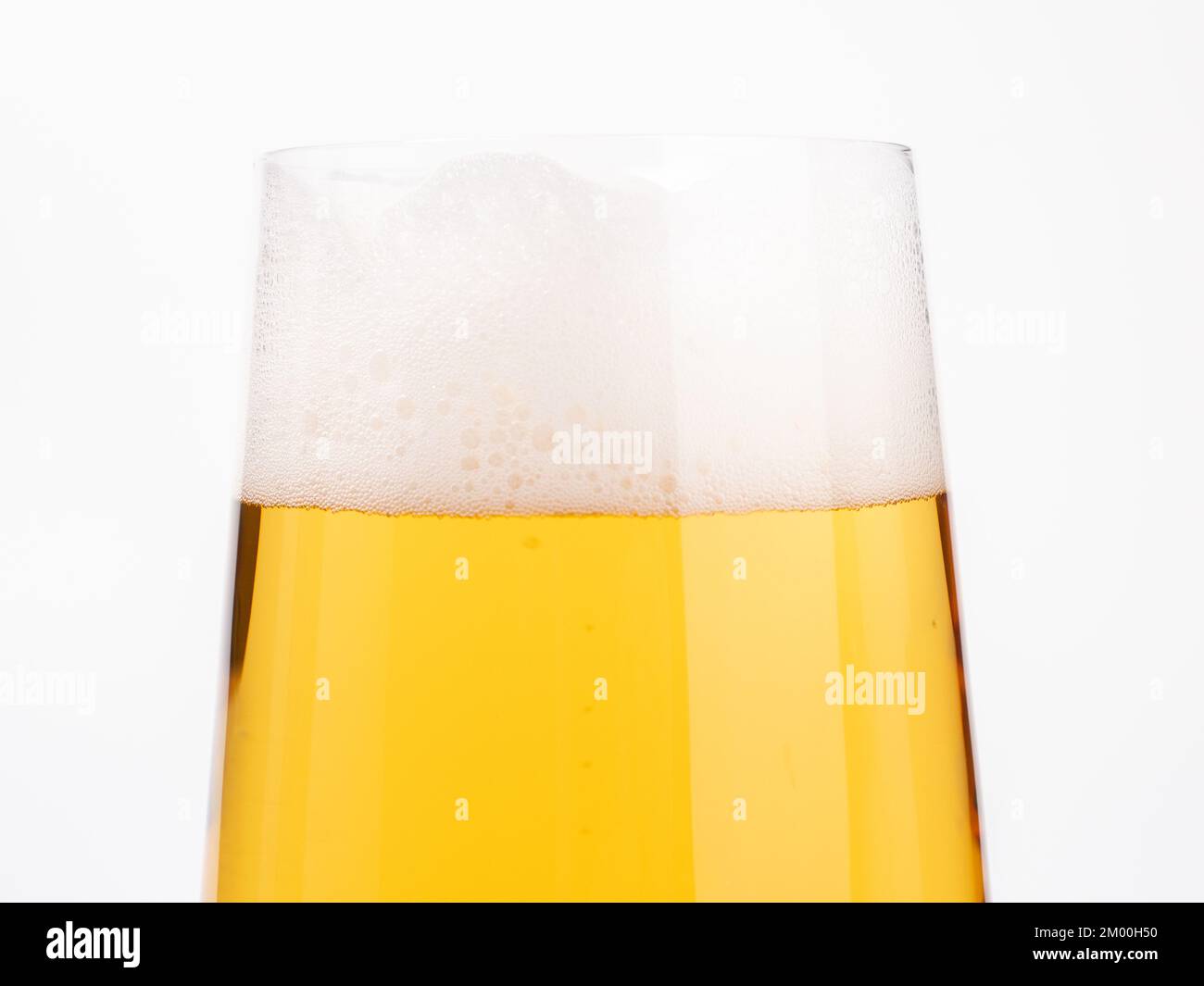 Glass of beer on a white background. A glass of light beer with foam ...