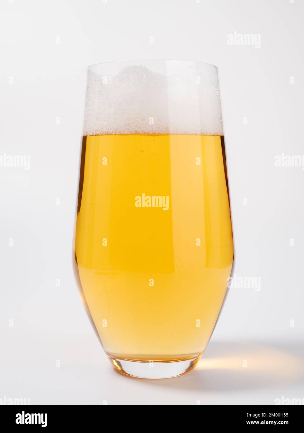 Glass of beer on a white background. A glass of light beer with foam ...