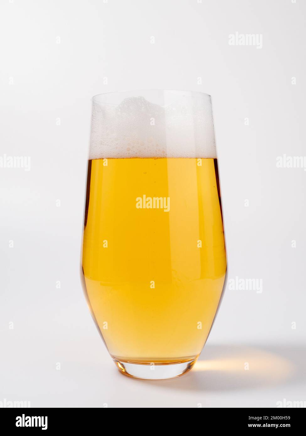 Glass of beer on a white background. A glass of light beer with foam ...