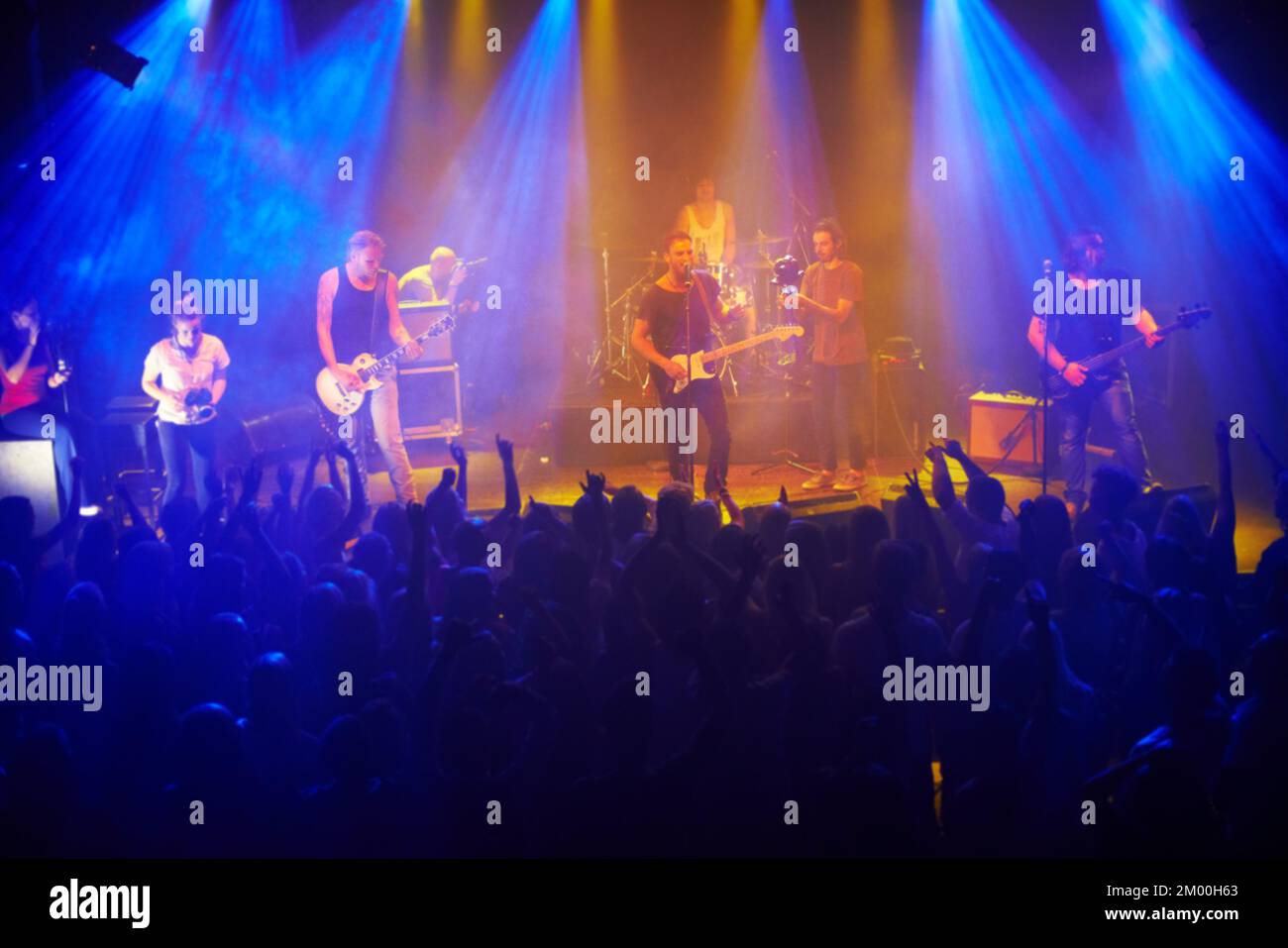 Music, live concert and band playing a song for audience at a rock ...
