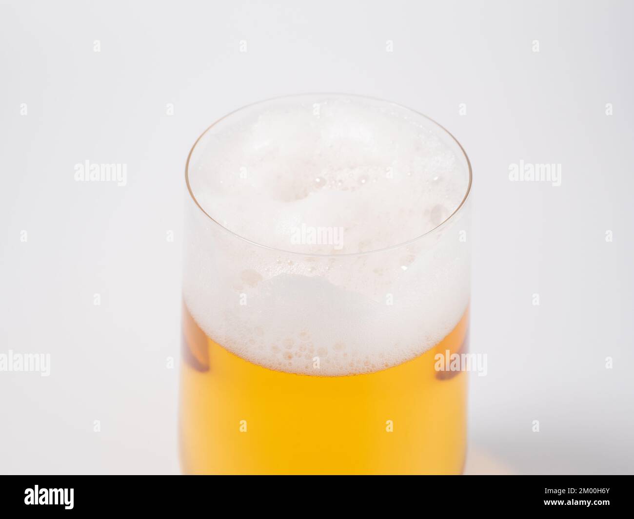 Glass of beer on a white background. A glass of light beer with foam ...