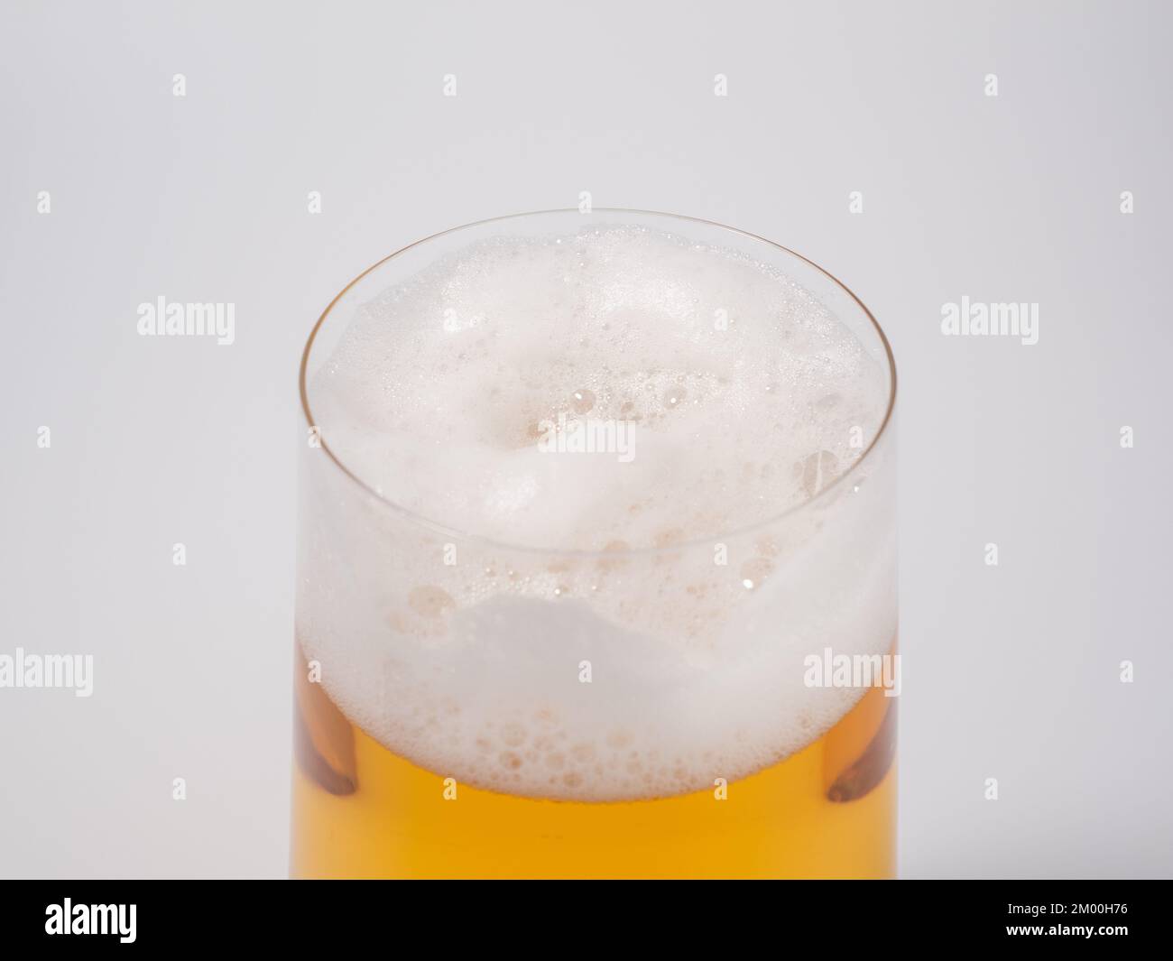 Glass of beer on a white background. A glass of light beer with foam ...