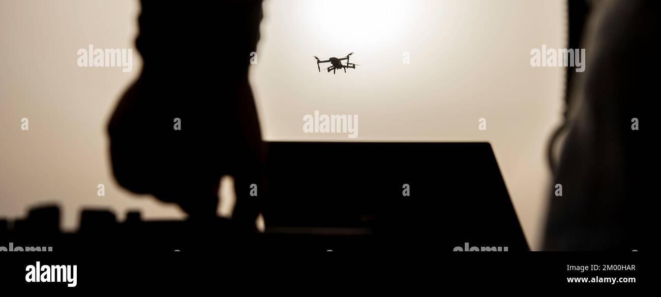 Horizontal banner with silhouette of drone pilot flying with quadcopter ...