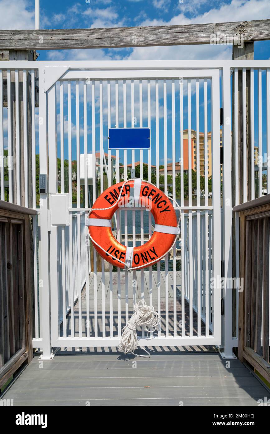Destin, Florida- Orange lifebuoy with Emergency Use Only hanging on a ...