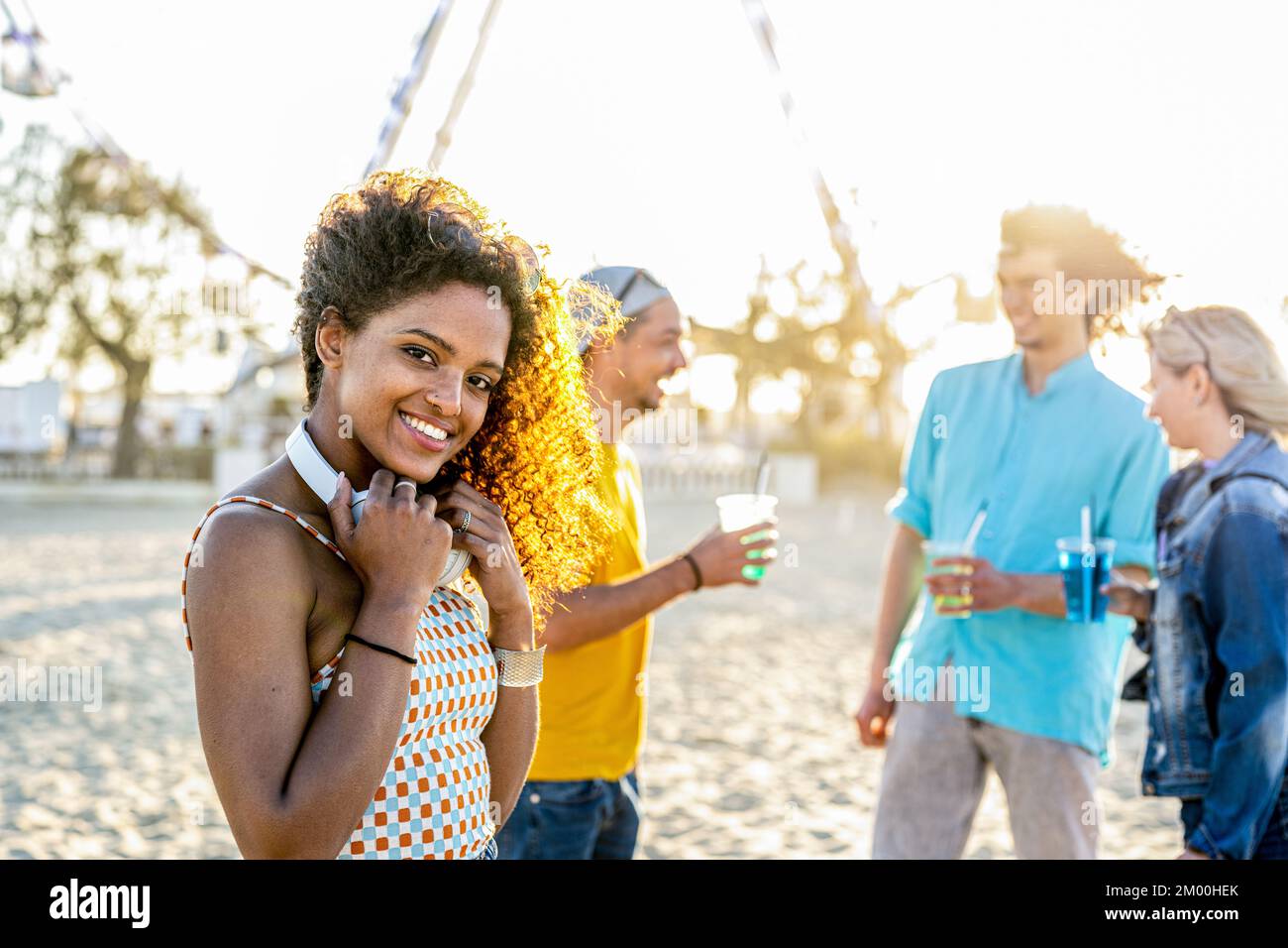 Young attractive beautiful woman looking at the camere while people on ...