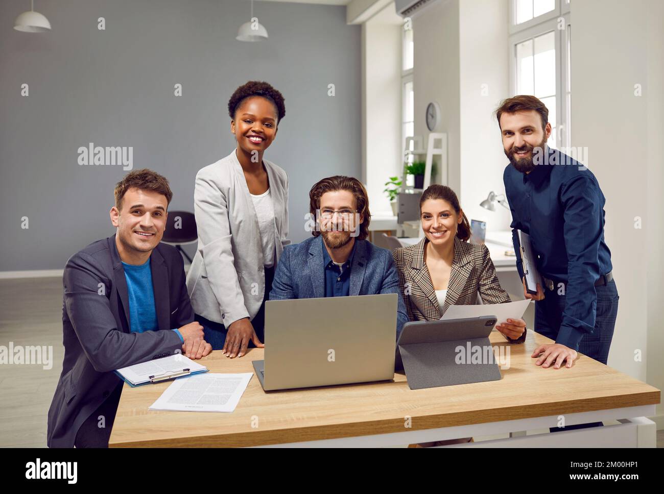 Portrait of friendly colleagues in office who discuss business ...