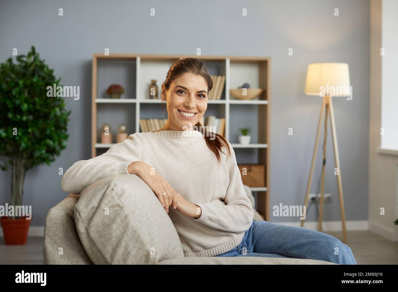 Portrait of a happy smiling good-looking young woman sitting on the ...