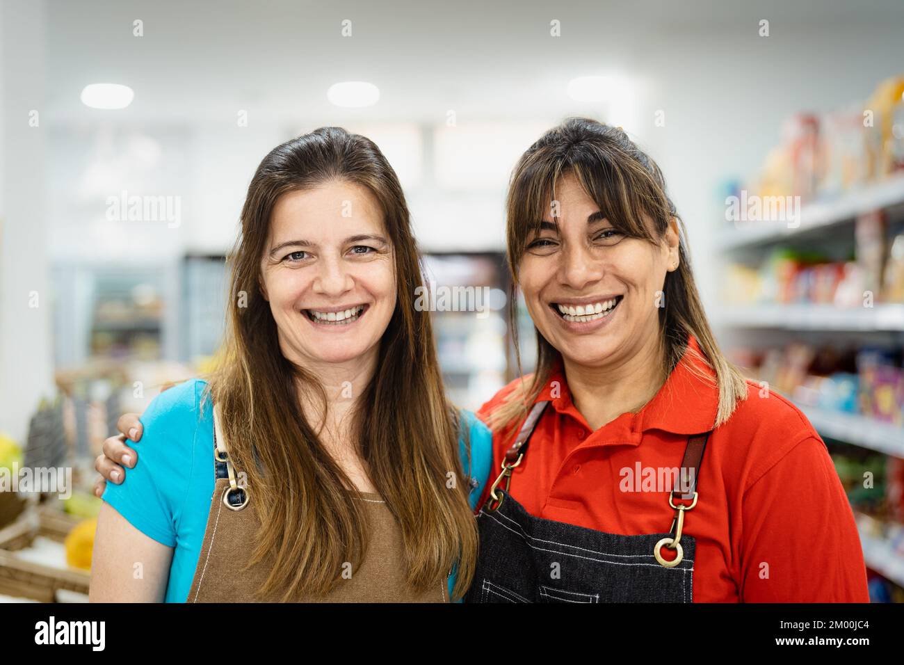 Happy women working inside supermarket Stock Photo - Alamy