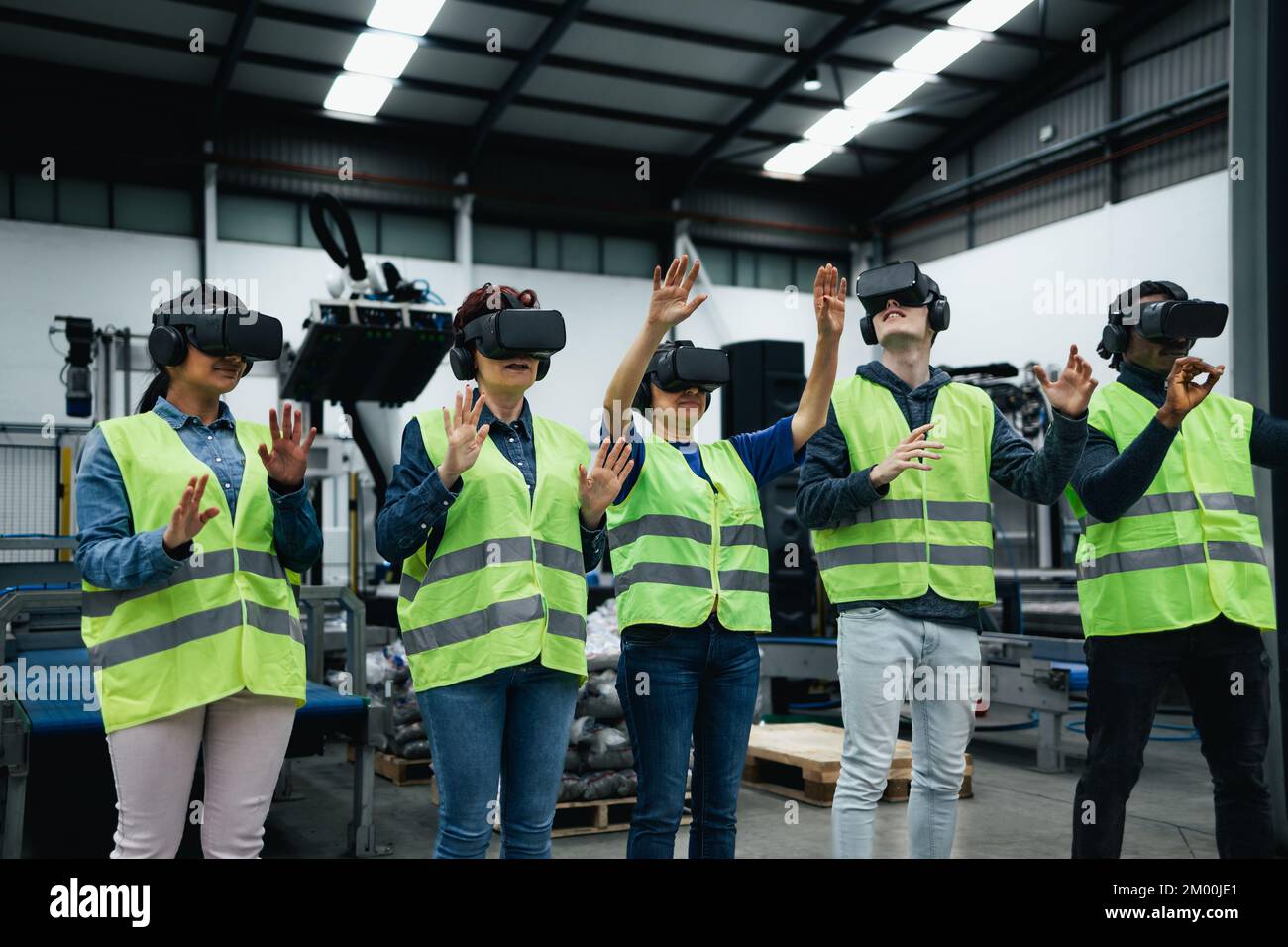 Team of engineers having simulation experience with futuristic virtual reality glasses inside ...
