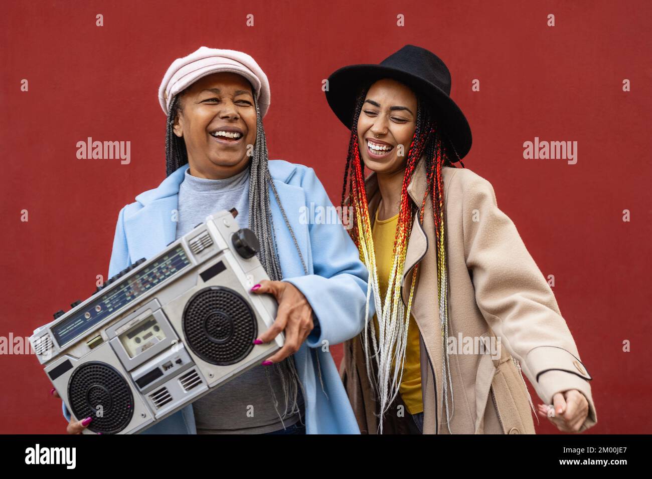 Happy African Mother With Her Daughter Having Fun Dancing And Listening Music With Vintage