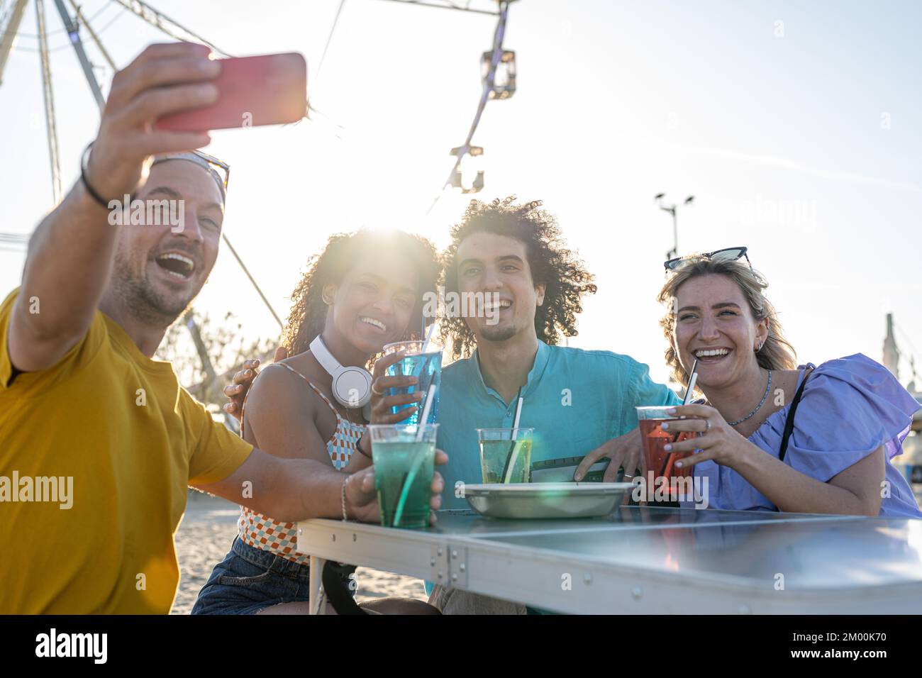 group of friends taking selfy at picnic party, four young people having ...