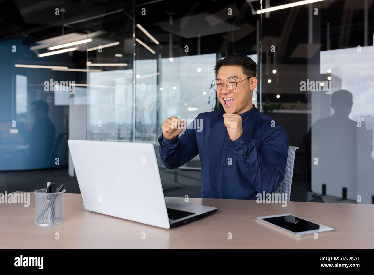 Successful businessman celebrating victory, man dancing sitting at ...