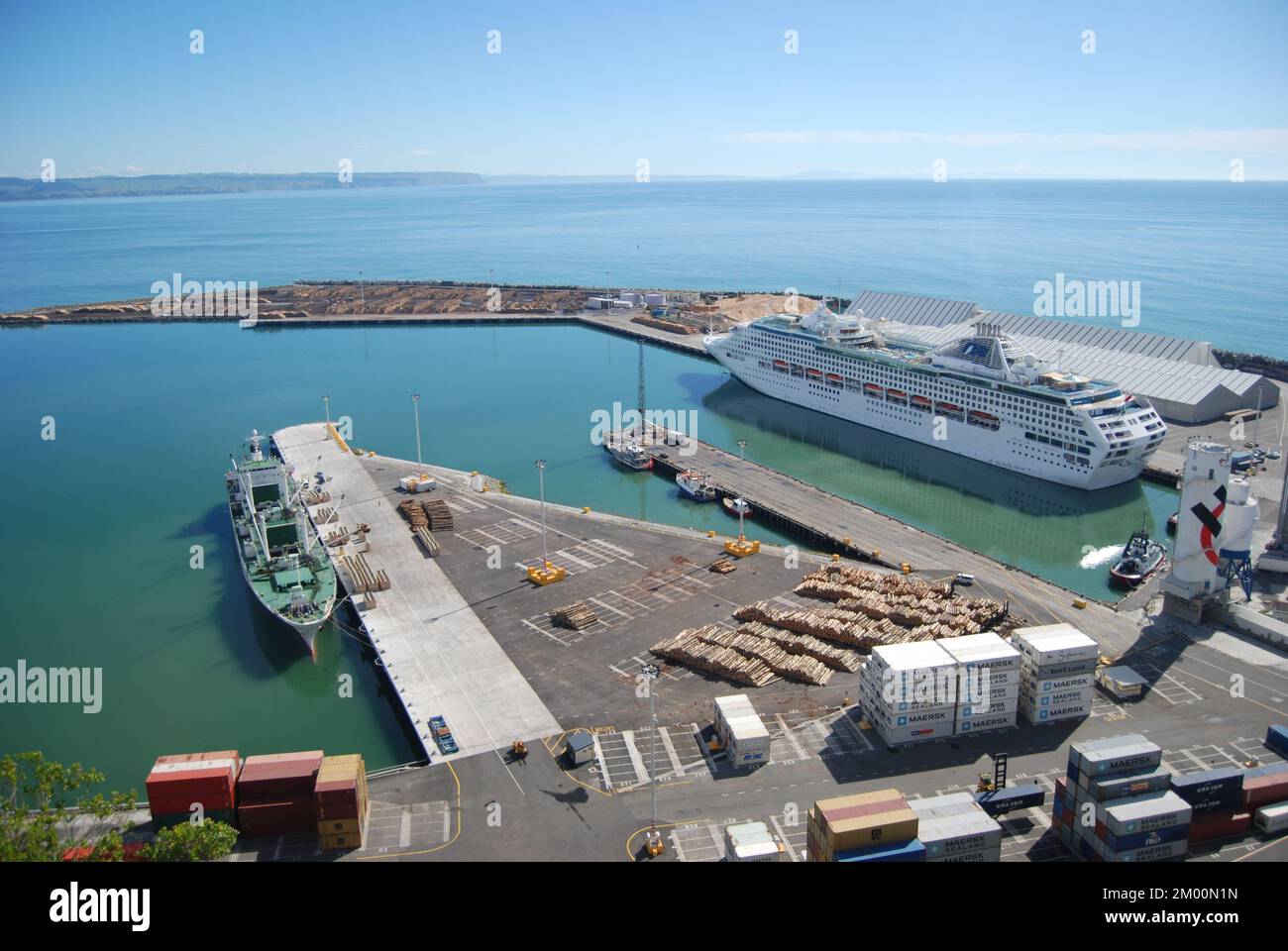 Napier Port in Hawke's Bay, New Zealand, Feb. 2010. Logs await export. A cargo ship is moored ...