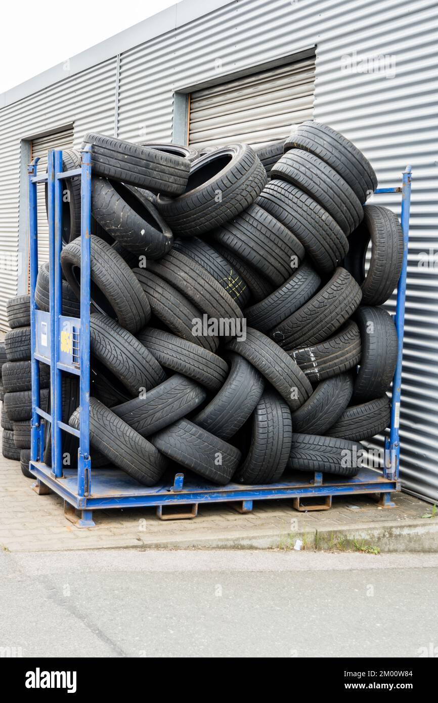 Old car tires in a container Stock Photo - Alamy