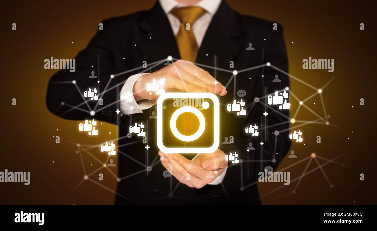 Hand holding social media icons Stock Photo - Alamy