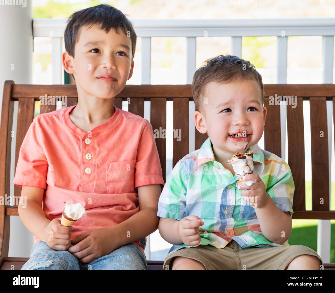 Two ethnic brothers eating hi-res stock photography and images - Alamy