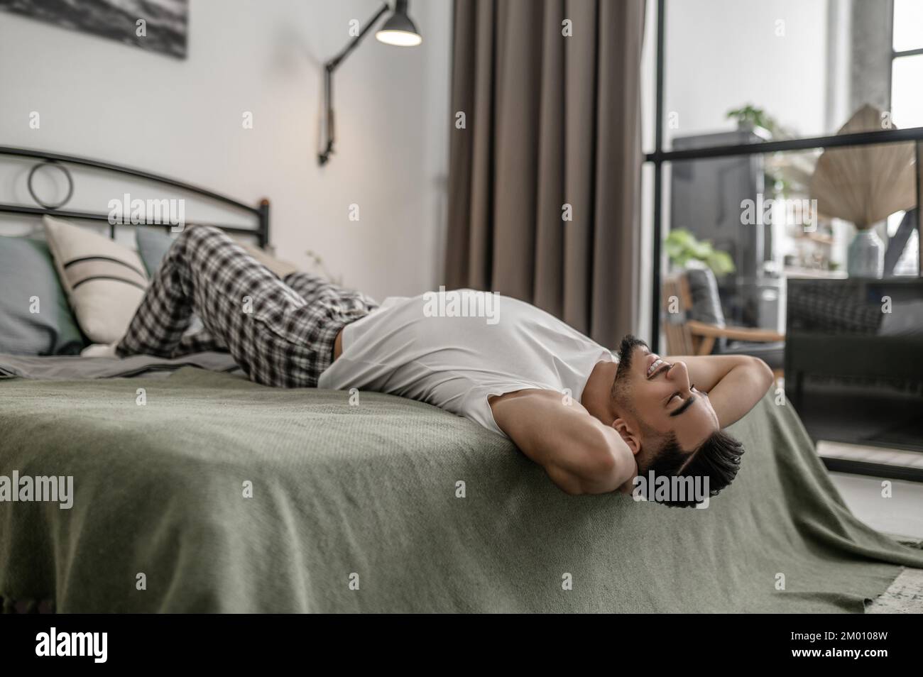 Man lying on a bed hi-res stock photography and images - Alamy