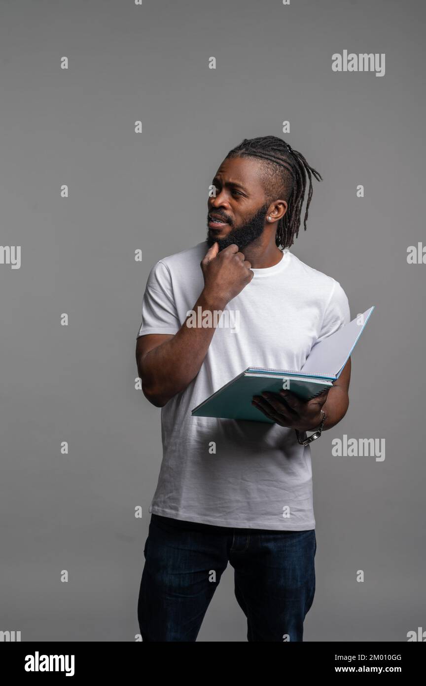Standing man looking thoughtful hi-res stock photography and images - Alamy