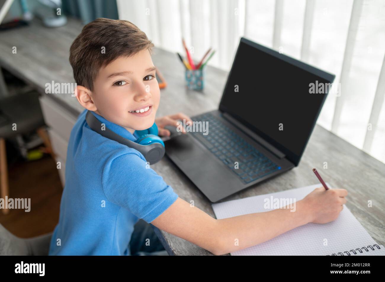 Cute boy sitting computer desk hi-res stock photography and images - Alamy