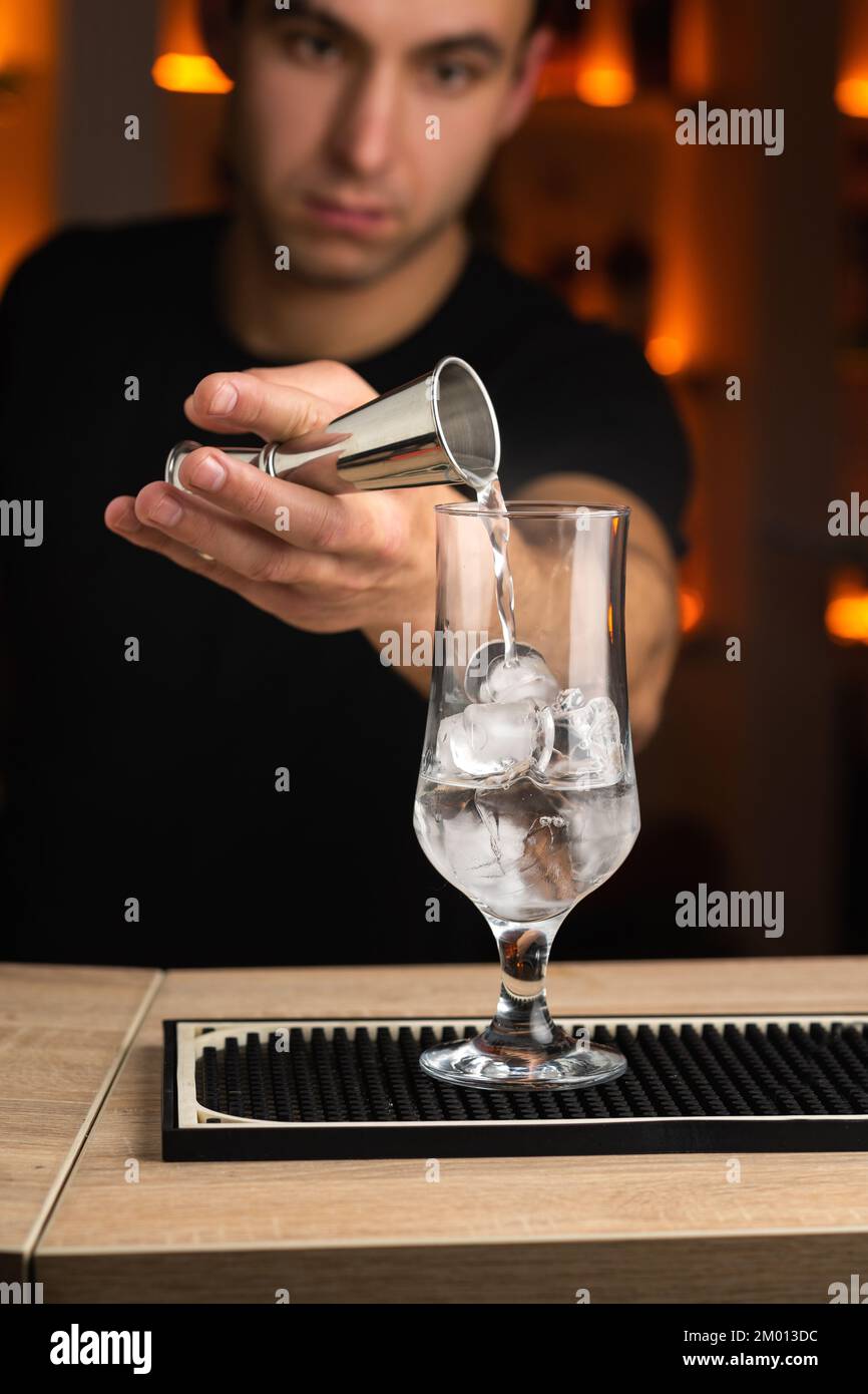 Process of preparing a cocktail bartender's in bar. Copy space Stock ...
