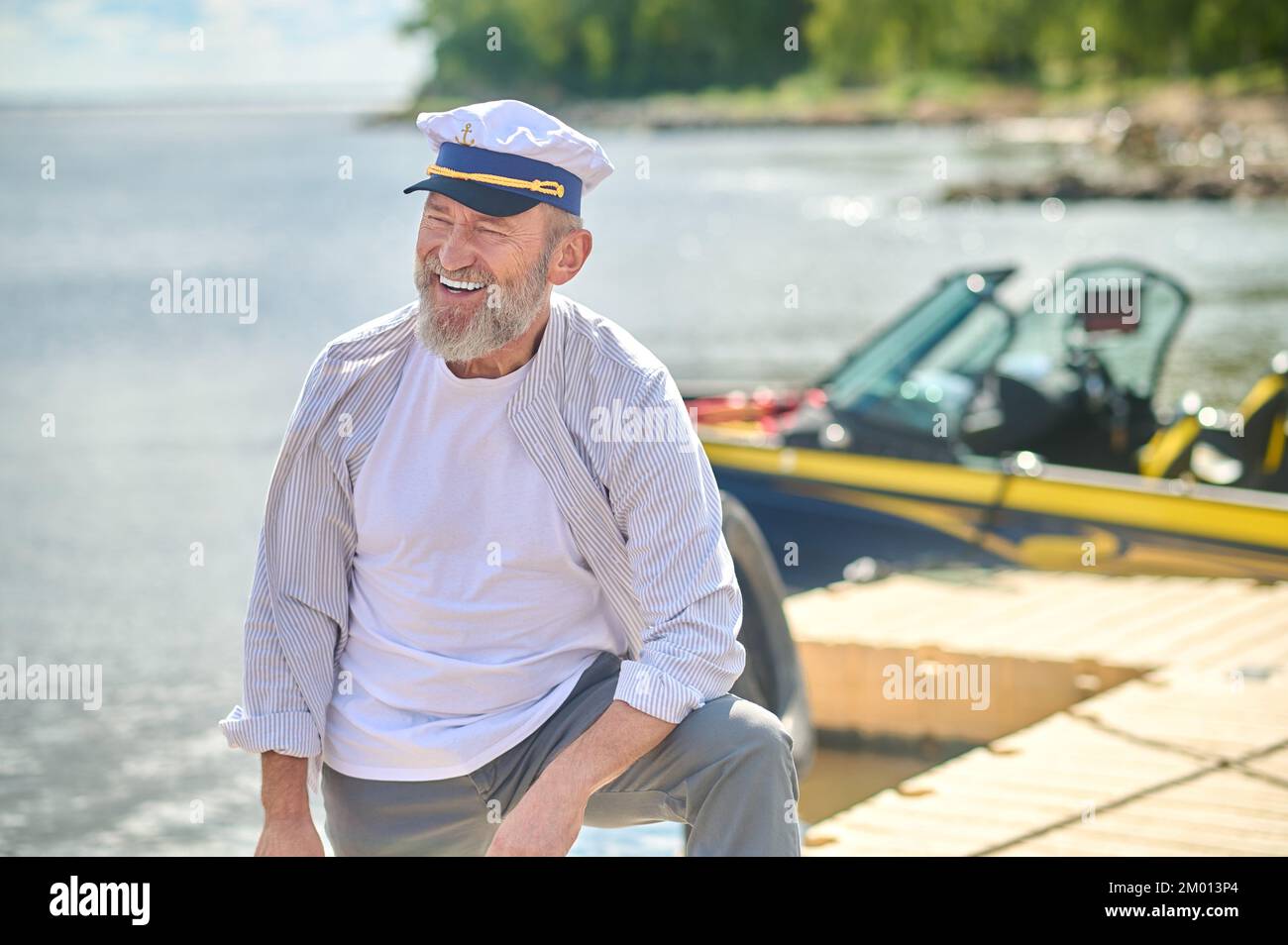 Captain. A bearded man in a captains cap looking contented Stock Photo ...