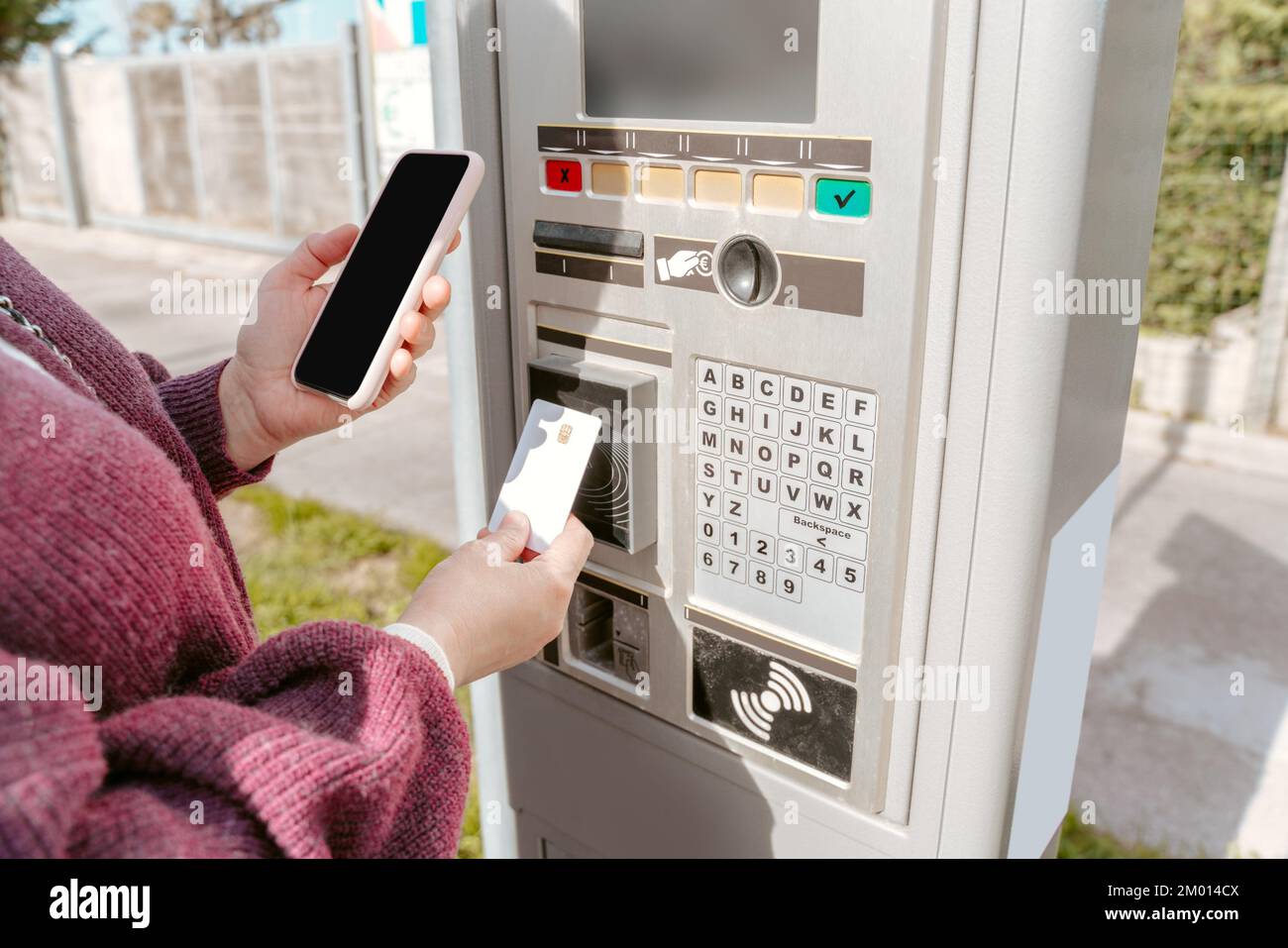 Cropped photo of a woman paying with a credit card for fuel at the self ...