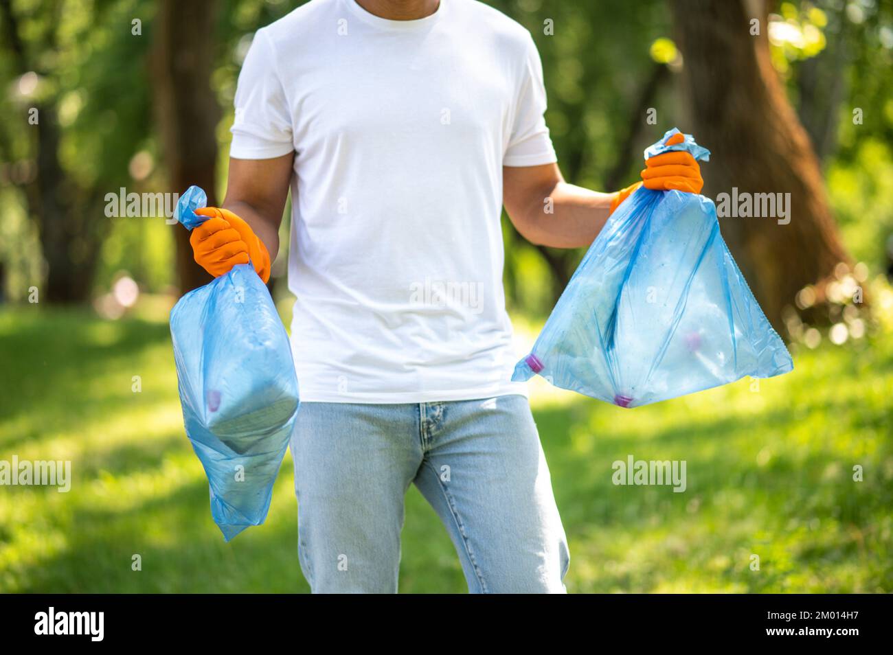Hand holding garbage bag hi-res stock photography and images - Alamy