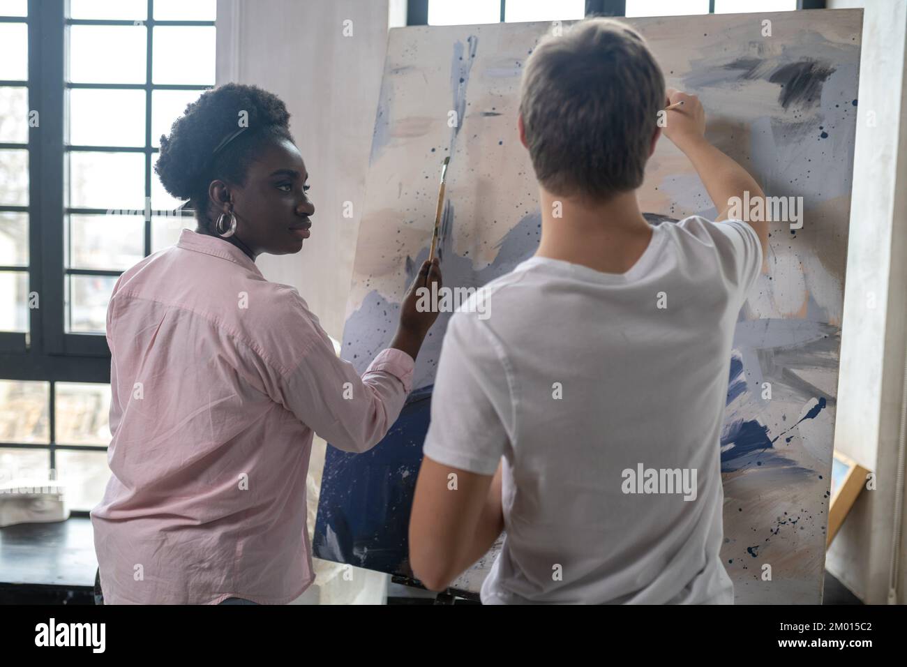 African american looking at easel hi-res stock photography and images ...