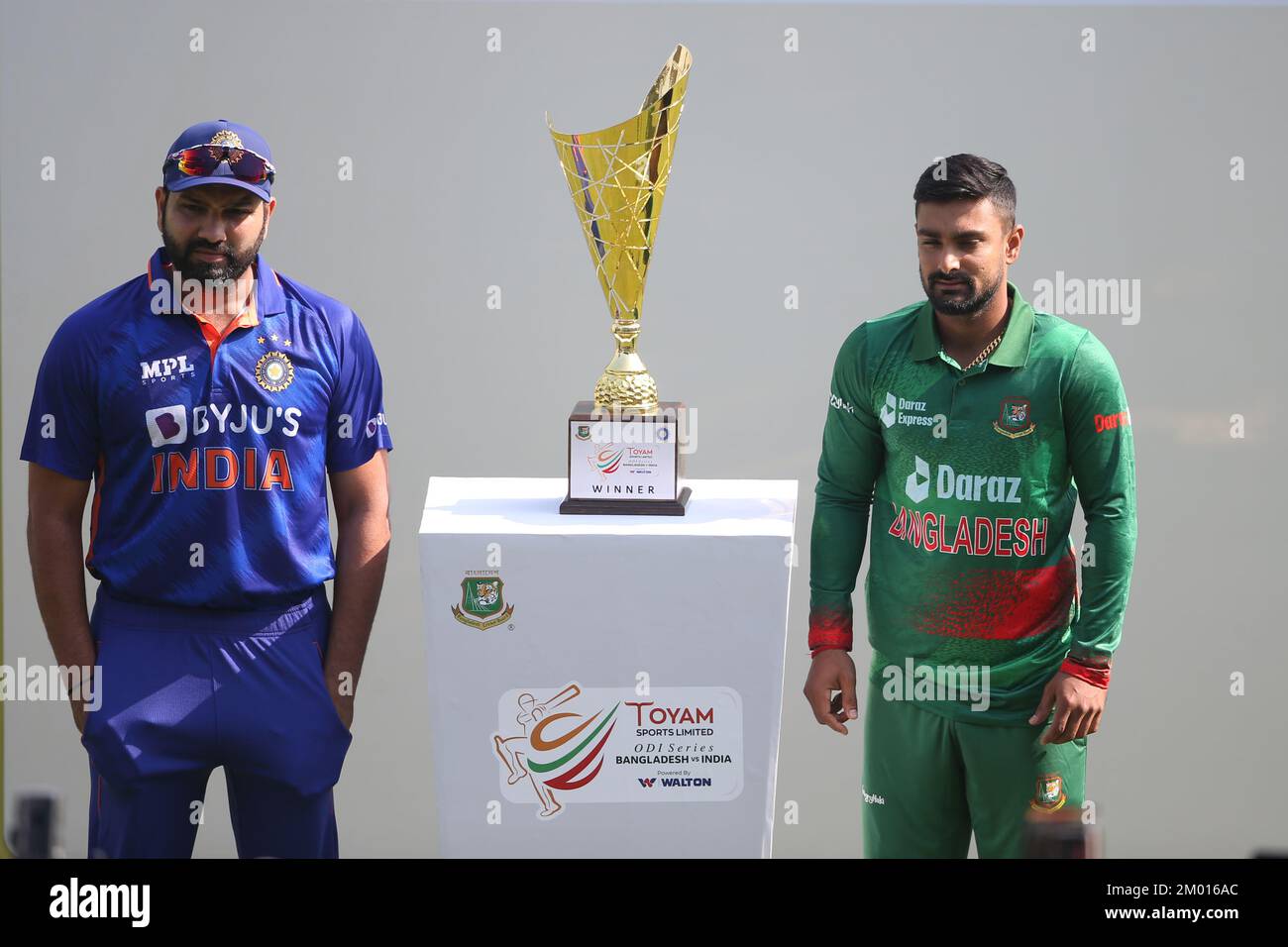 Bangladeshi Captain Liton Kumar Das ® and Indian Captain Rohit Sharma (L) unveil the trophy of ...