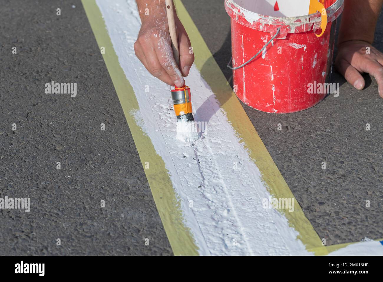 Road marking is applied by hand with a brush Stock Photo - Alamy