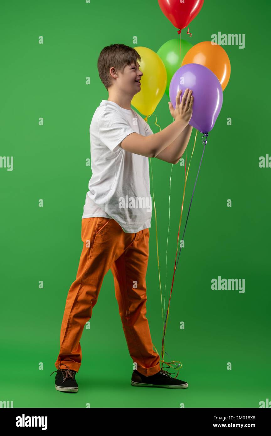 Bday. Young boy with balloons looking happy and excited Stock Photo - Alamy