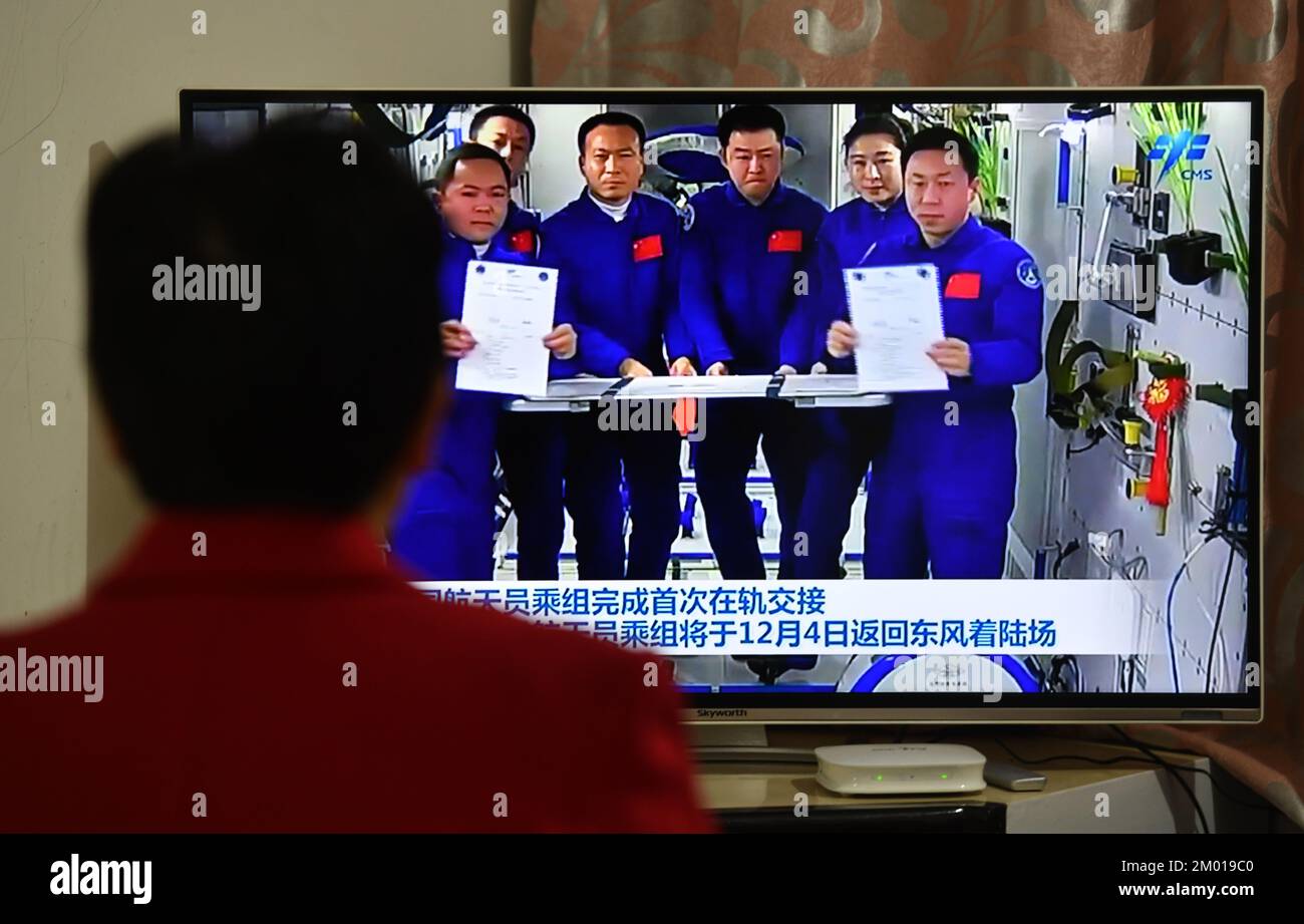 FUYANG, CHINA - DECEMBER 3, 2022 - Citizens watch TV news showing the ...