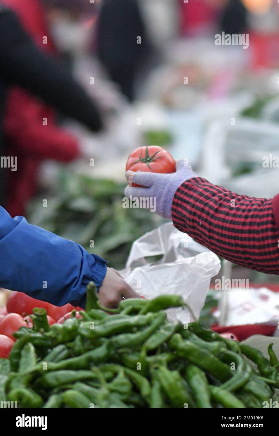 BAZHOU, CHINA - DECEMBER 3, 2022 - People shop at a market in Bazhou ...