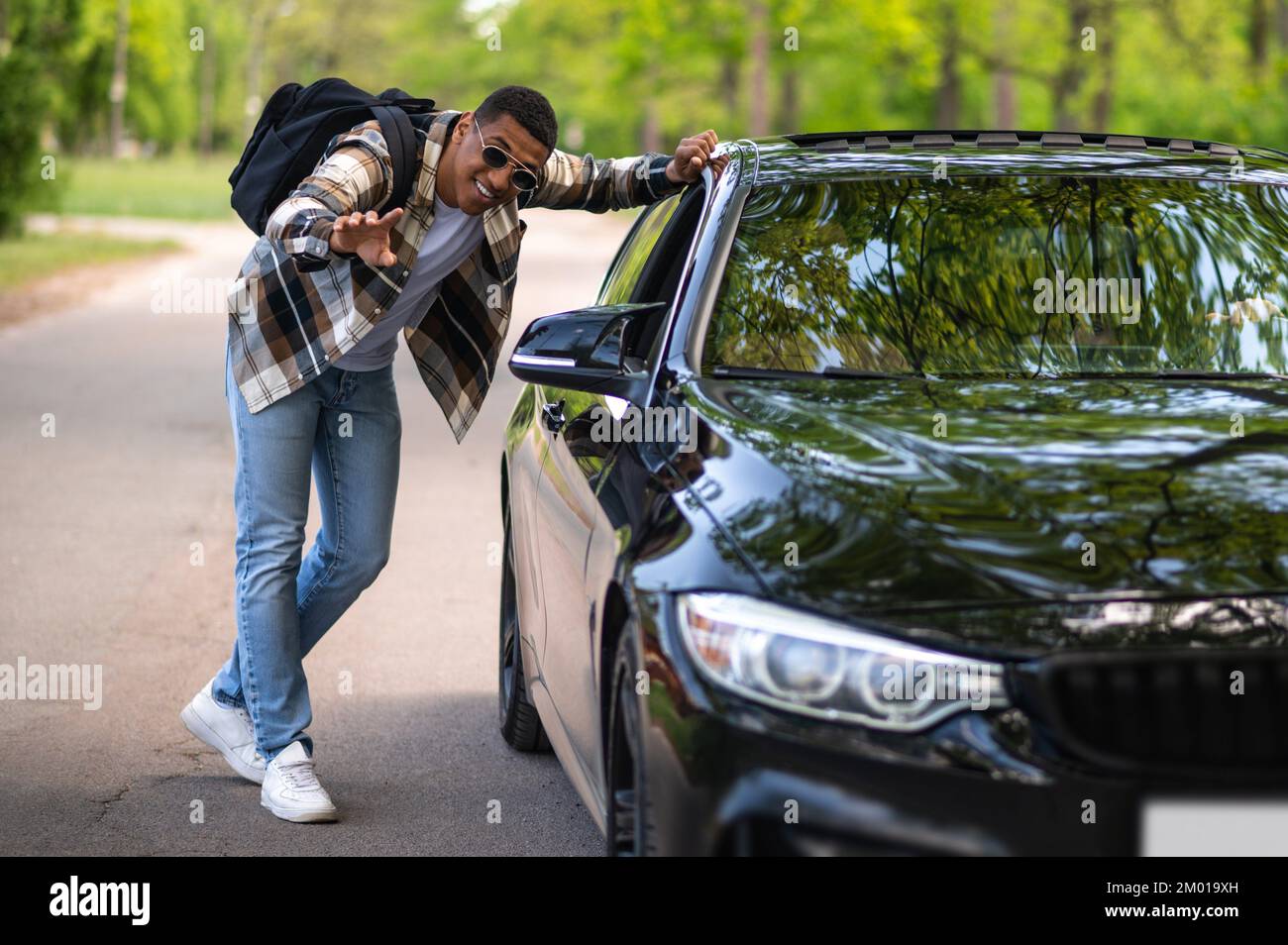 Asking the way. Young man on the road flirting with a female driver ...