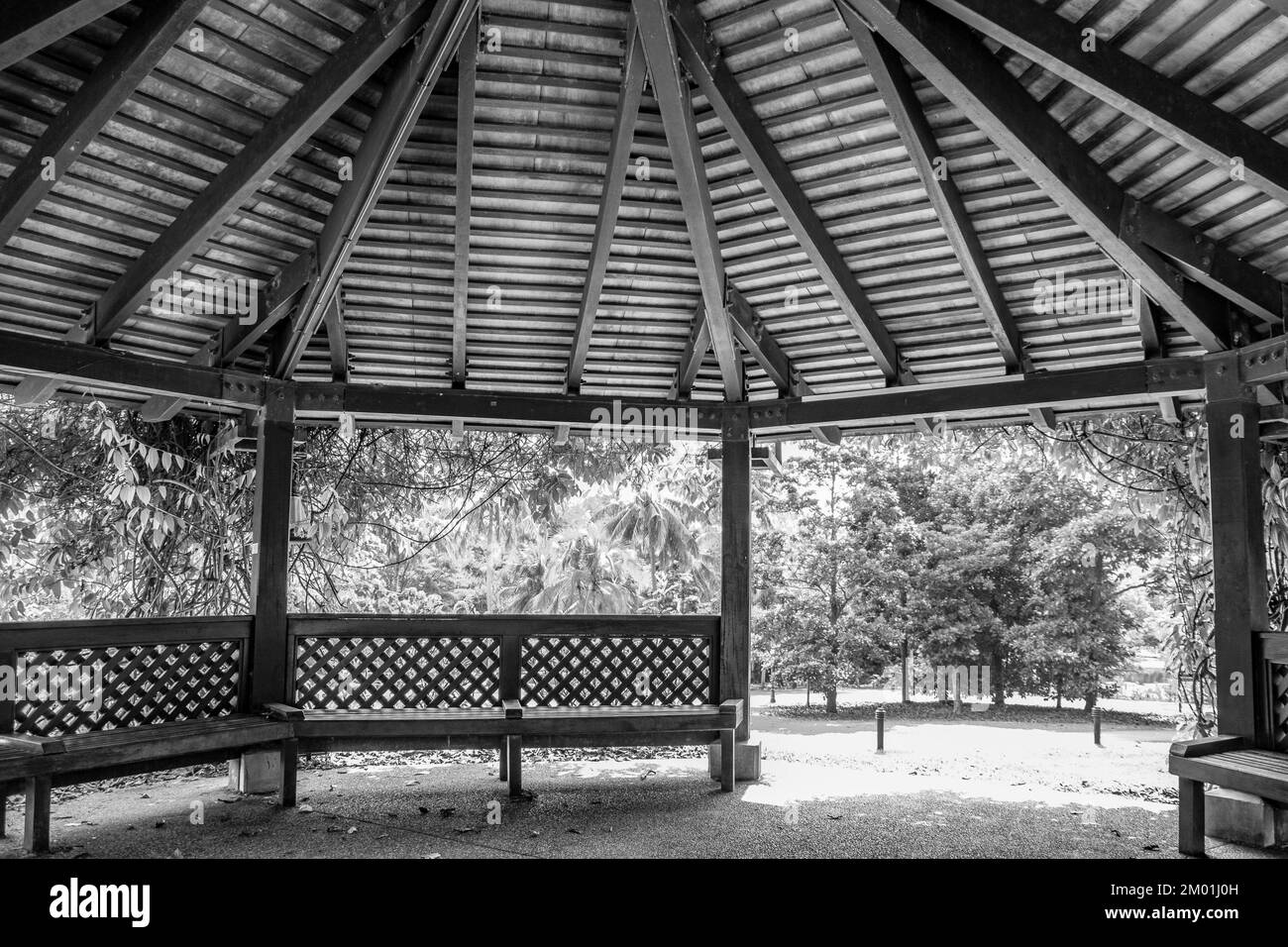 Seats under a roof to hide from the rain in a park Stock Photo - Alamy