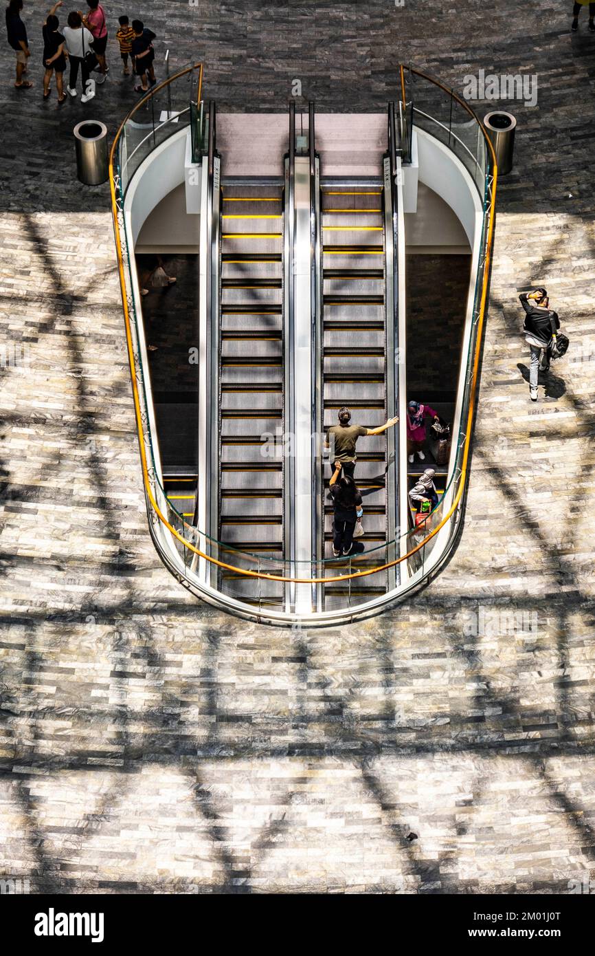 People using the escalator to Jewel; the world’s tallest indoor ...