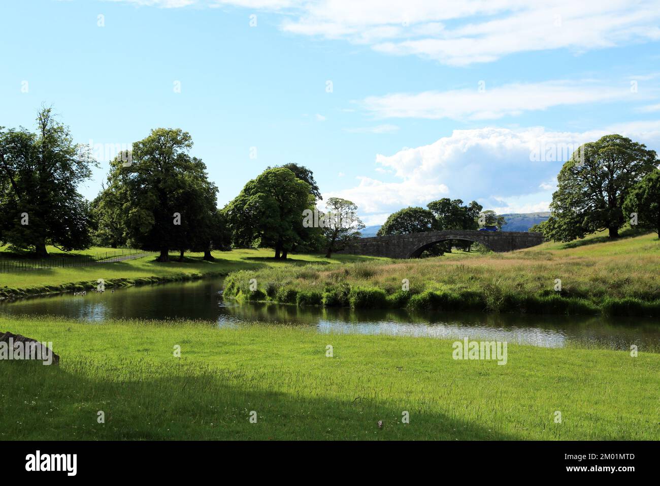 View of Milnthorpe Bridge and River Bela from parkland at Dallam Towers ...