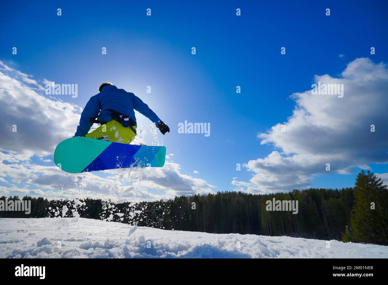 young man on the snowboard jumping over the slope in winter Stock Photo ...